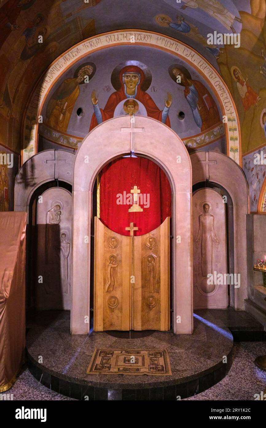 A side alcove with red velvet curtain, perhaps for confession. At the ...
