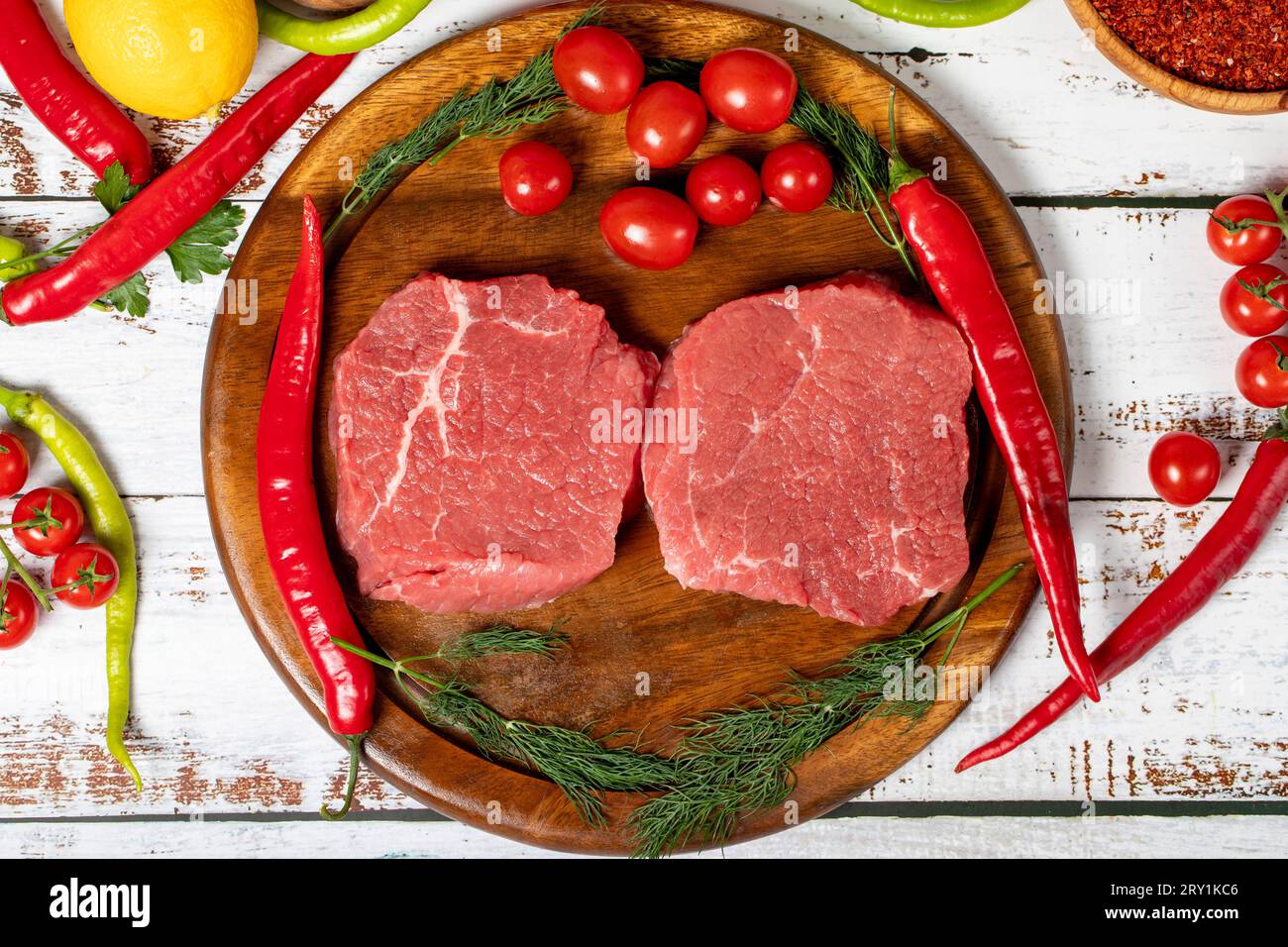 Beef round slice on wood background. Raw beef round with herbs and ...