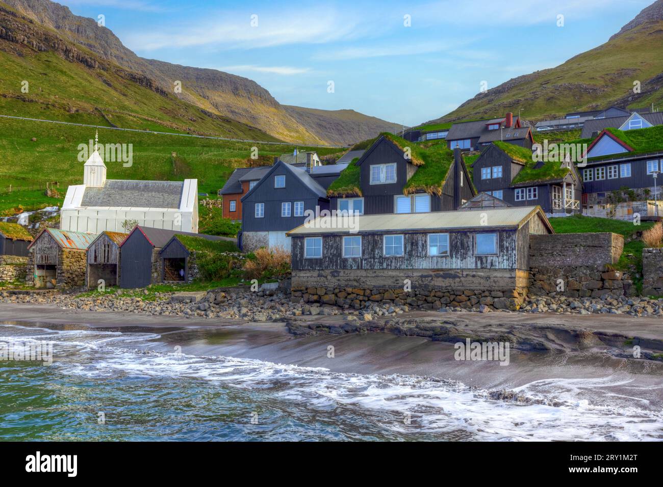Turfed Houses and sea stack Tindholmur in Bour, Faroe Islands Stock ...
