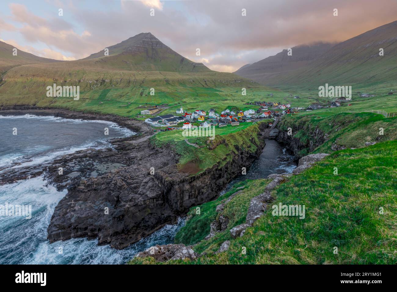 The village of Gjogv and its natural harbour in the Faroe Islands Stock ...