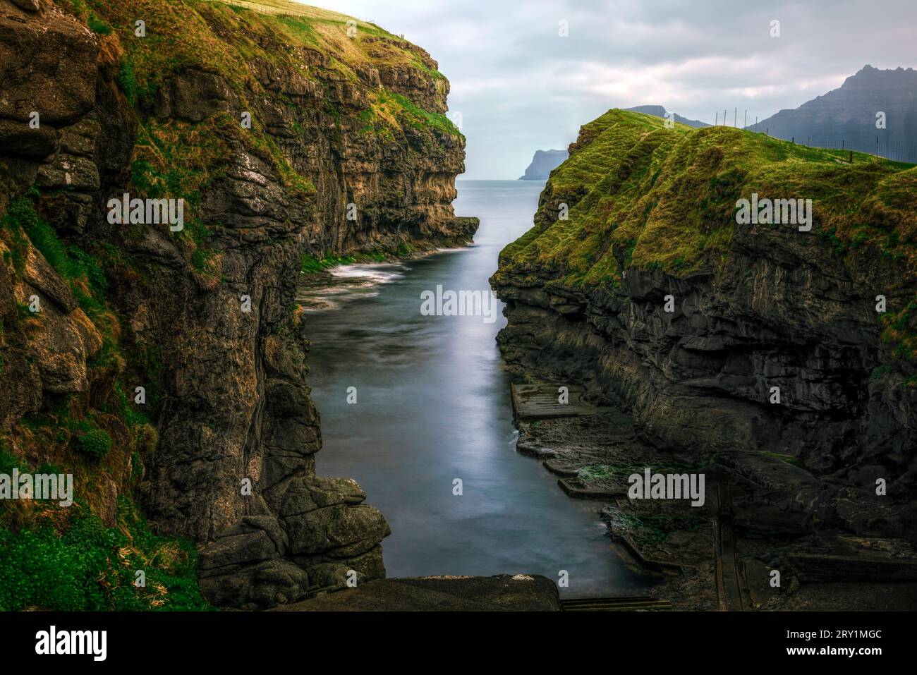 The village of Gjogv and its natural harbour in the Faroe Islands Stock ...