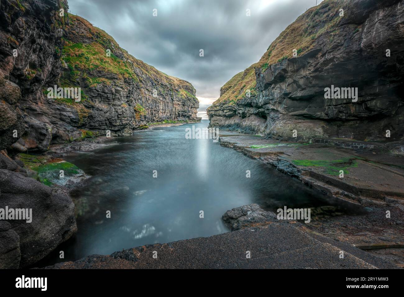 The village of Gjogv and its natural harbour in the Faroe Islands Stock ...