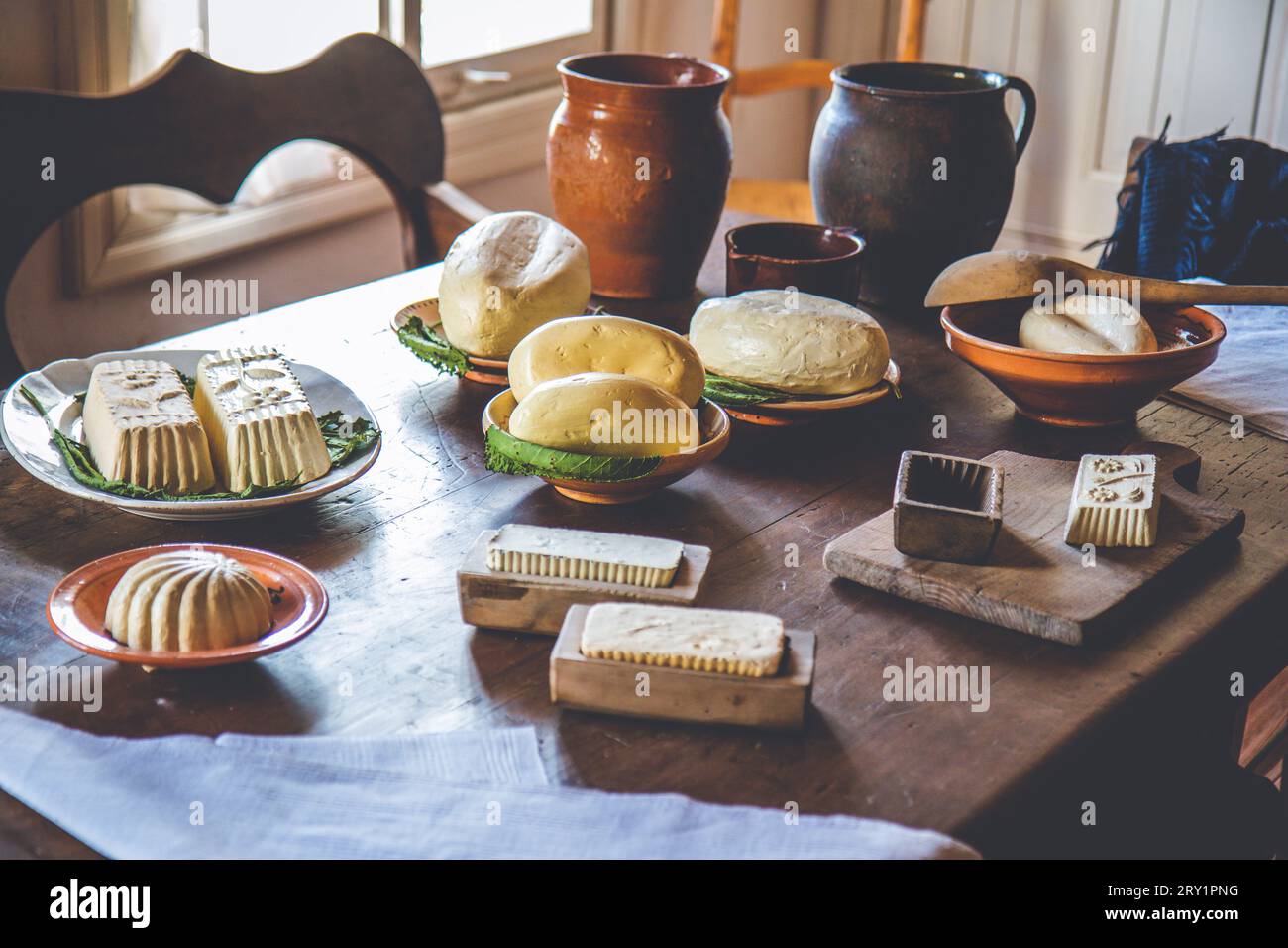 Manufacturing butter in traditional way in kitchen of nobility manor ...