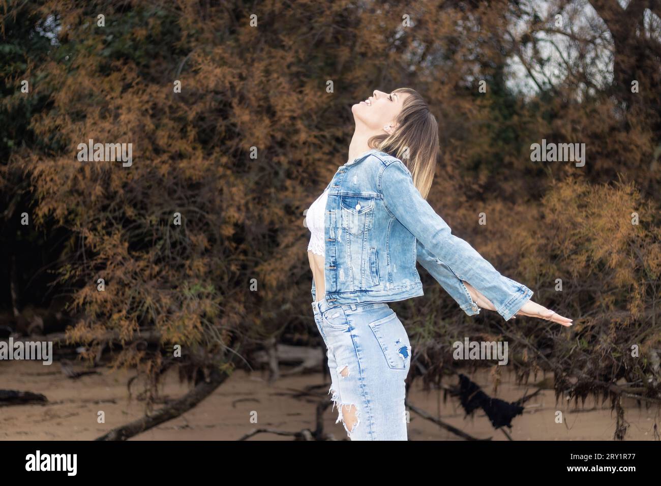 Breathtaking Coastal Beauty: Radiant Woman in Denim and Lace by the ...
