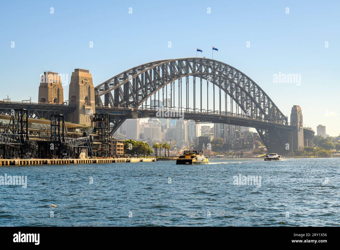 Sydney Harbour Bridge with ferries and Sydney North buildings in the ...