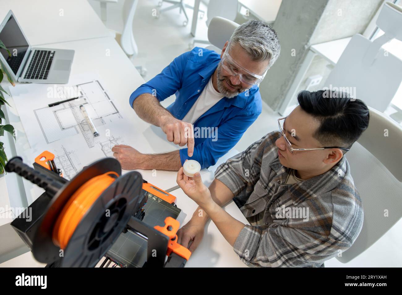 Scientists involved in setting up and developing 3D printers in the modern laboratory Stock ...