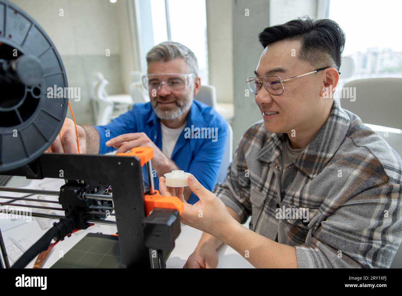 Scientists involved in setting up and developing 3D printers in the ...