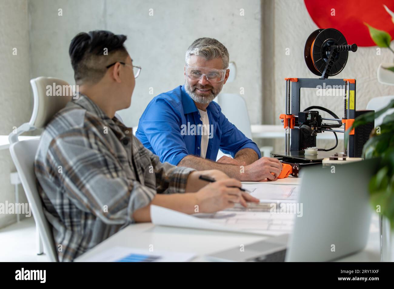 Architects Working With 3d Printer And Projecting House Model Drawing Blueprint Using Laptop