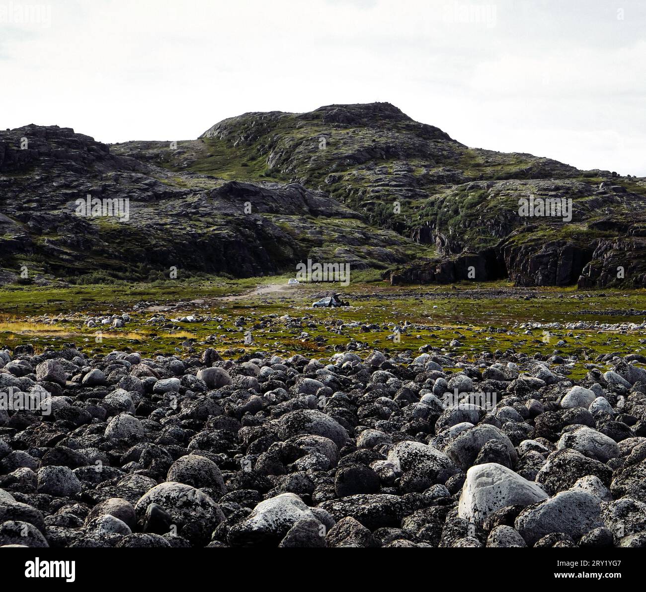 Gloomy landscape of polar tundra. Coast and hills with stones covered ...