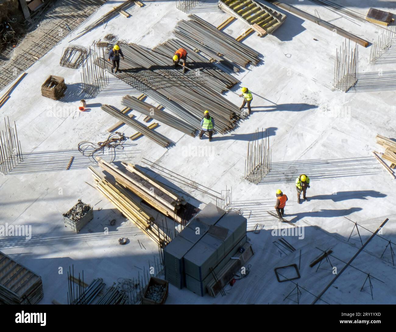 Group of workers working with a metal rebars at the construction site ...