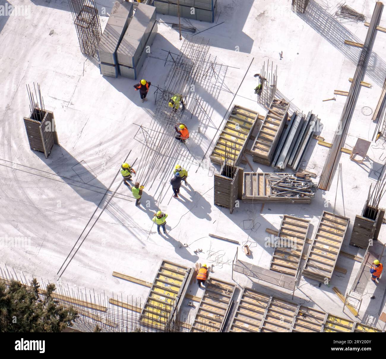 Workers in orange and yellow uniform working with reinforcement at the ...