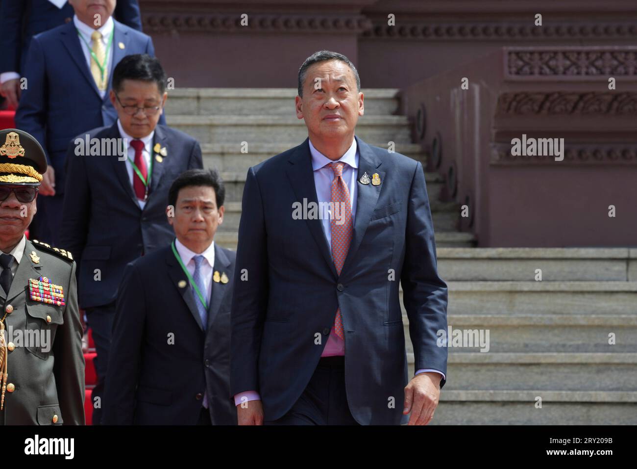 Thai Prime Minister Srettha Thavisin, right, walks after a ceremony at ...