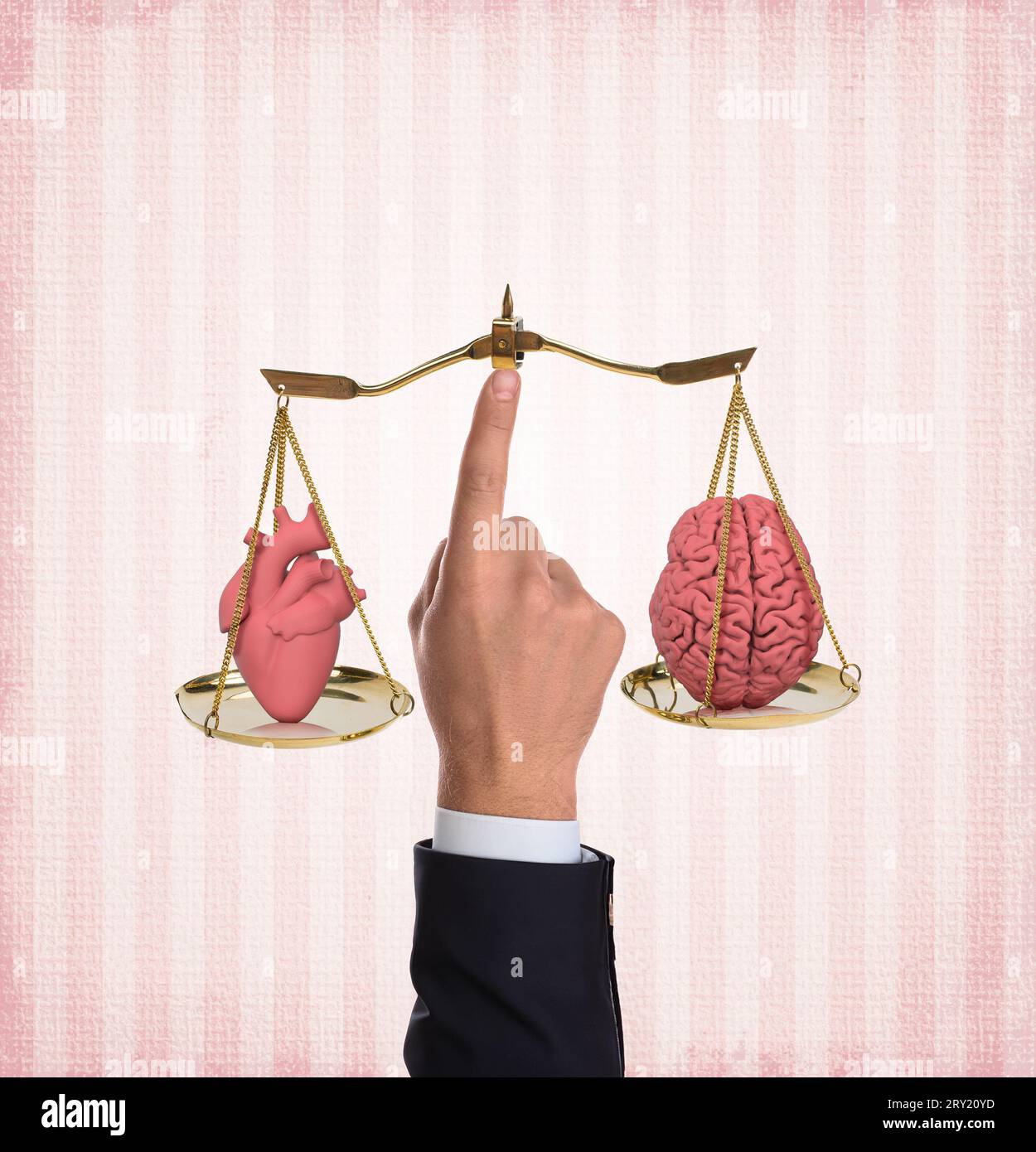 Heart and brain balance. The man holds the scales with his finger and ...
