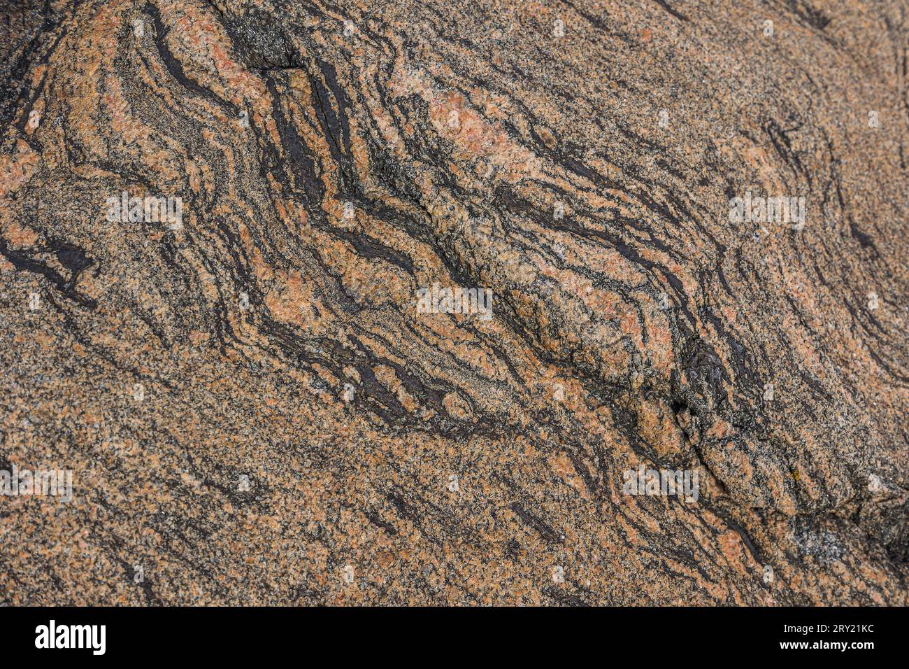 Granite surface in brown color. Stone structure with wavy curved lines ...