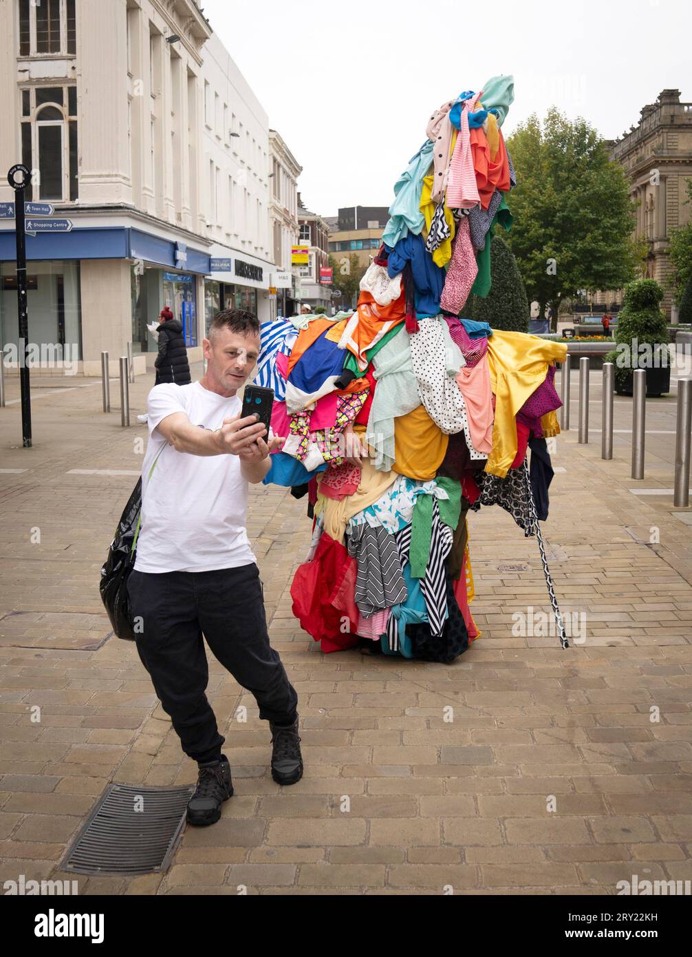 A man takes a selfie with artist Jeremy Hutchison as he performs as a ...