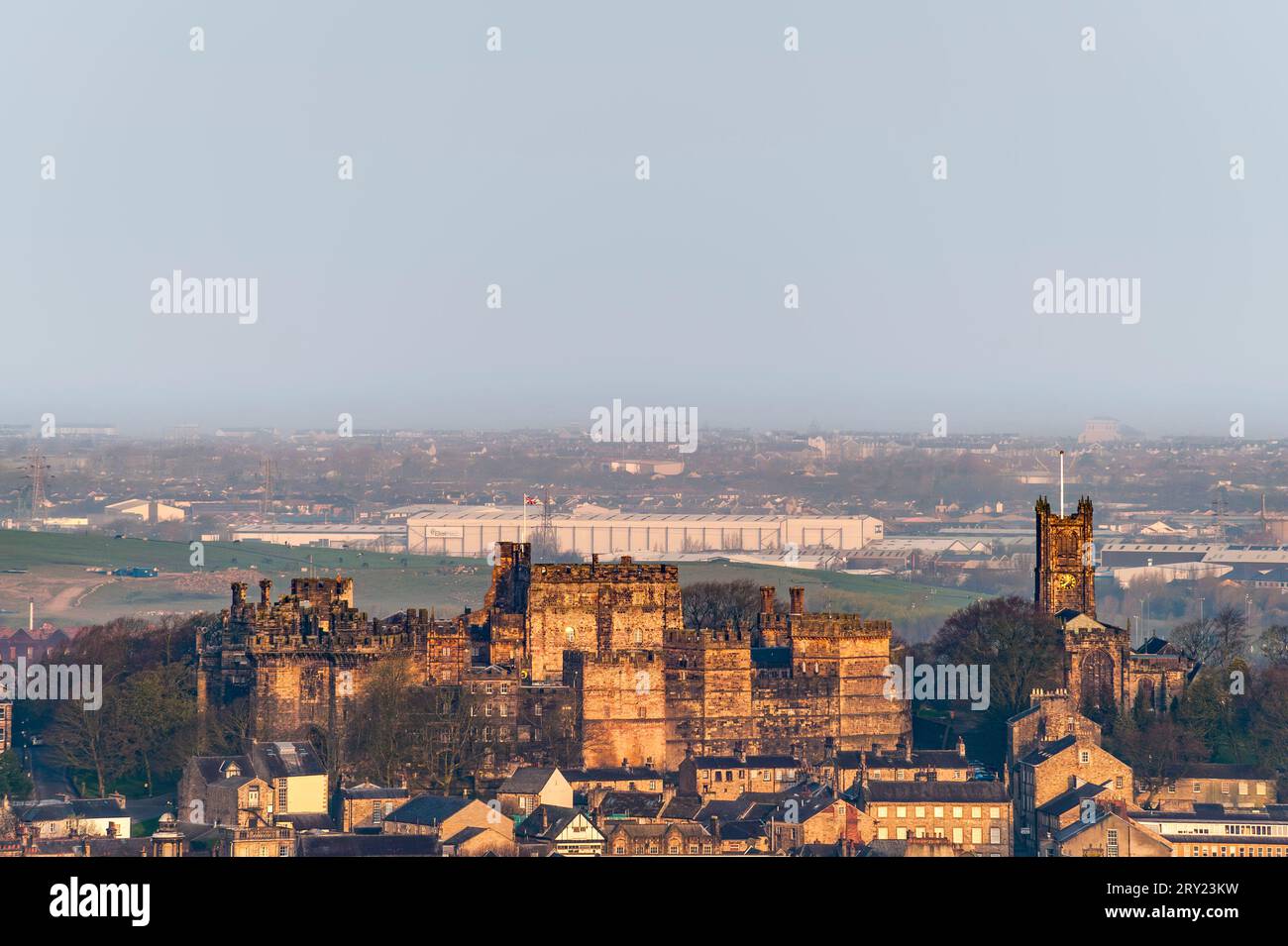 The old prison of Lancaster Castle towers over the city in an early ...