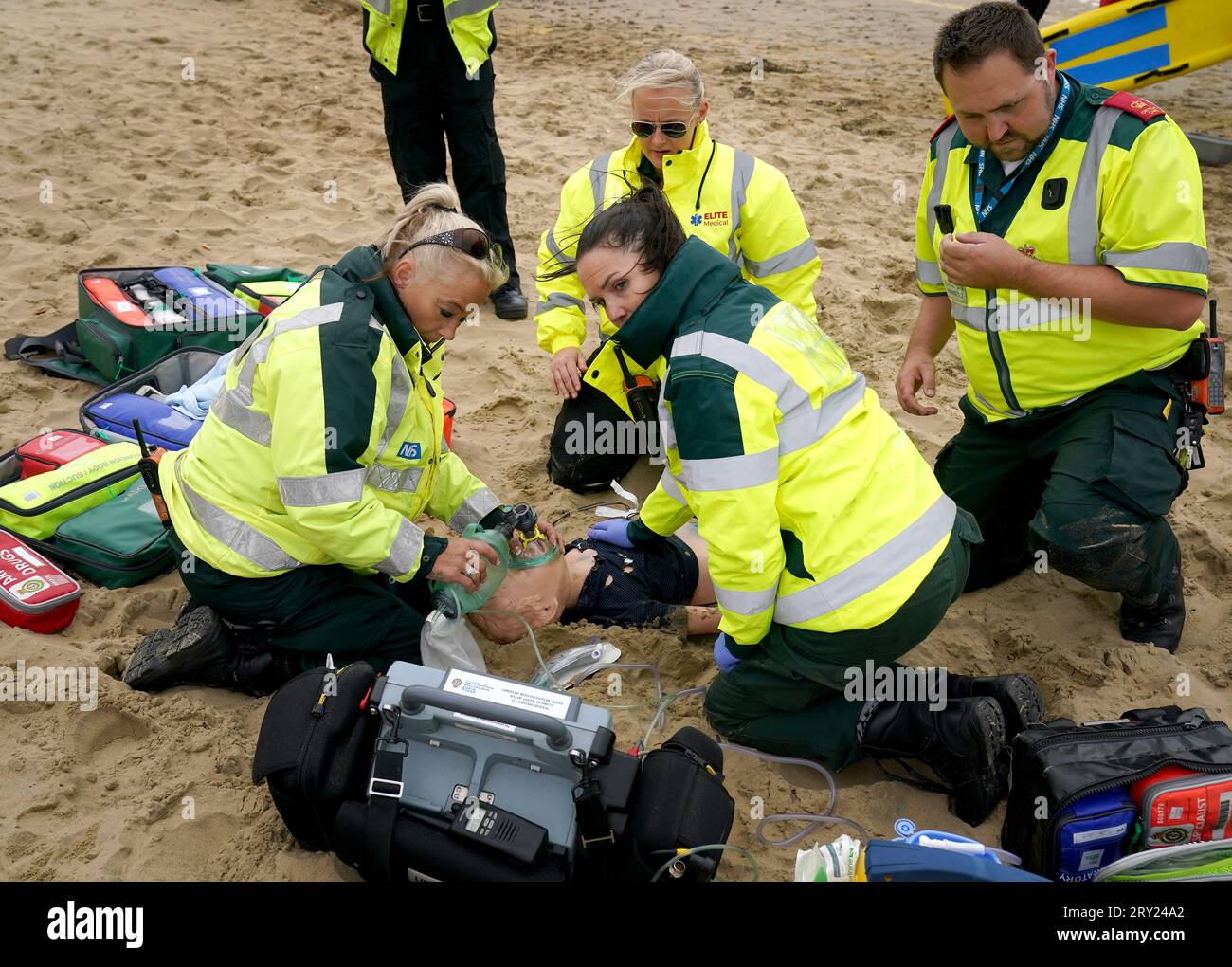 An ambulance crew practice their lifesaving skills on a dummy of a ...