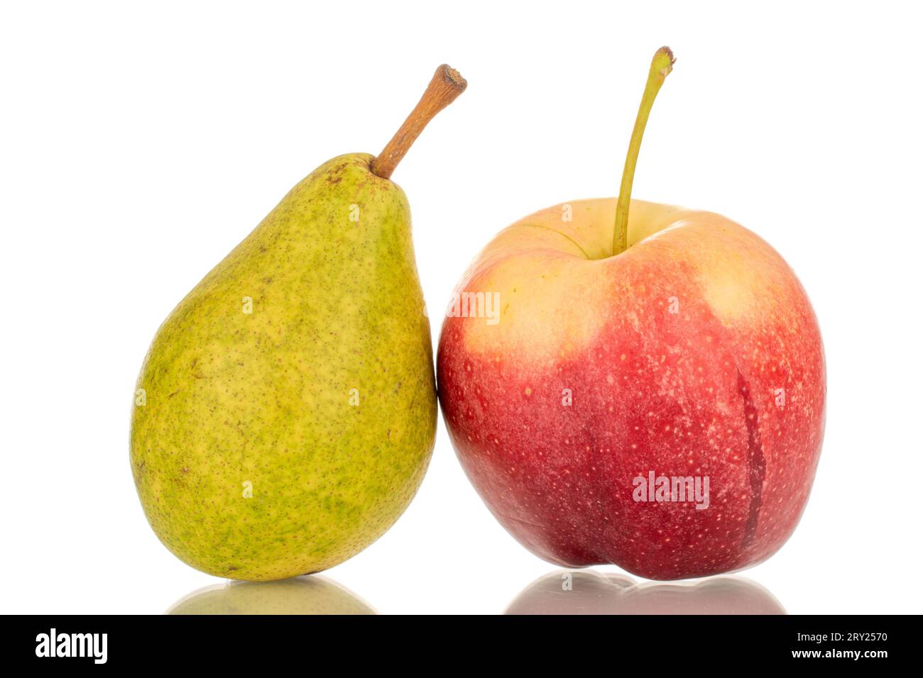 One red apple and one green pear, macro, isolated on white background ...