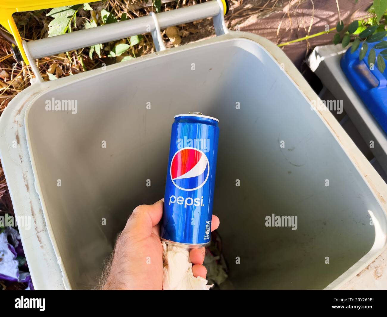 Paris, France - Sep 27, 2023: A male hand is seen disposing of an empty ...