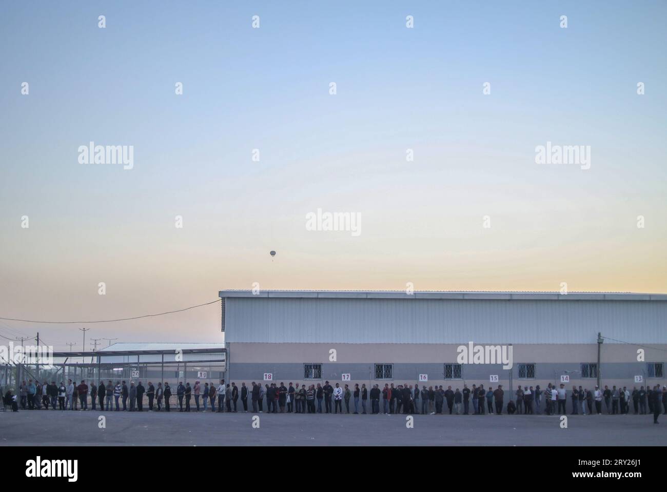 Palestinian workers gather at the Erez crossing between Israel and the ...