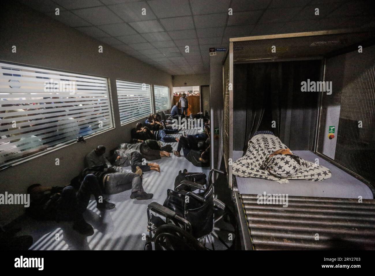 Palestinian workers nap in the scanning machine room wait to transfer ...