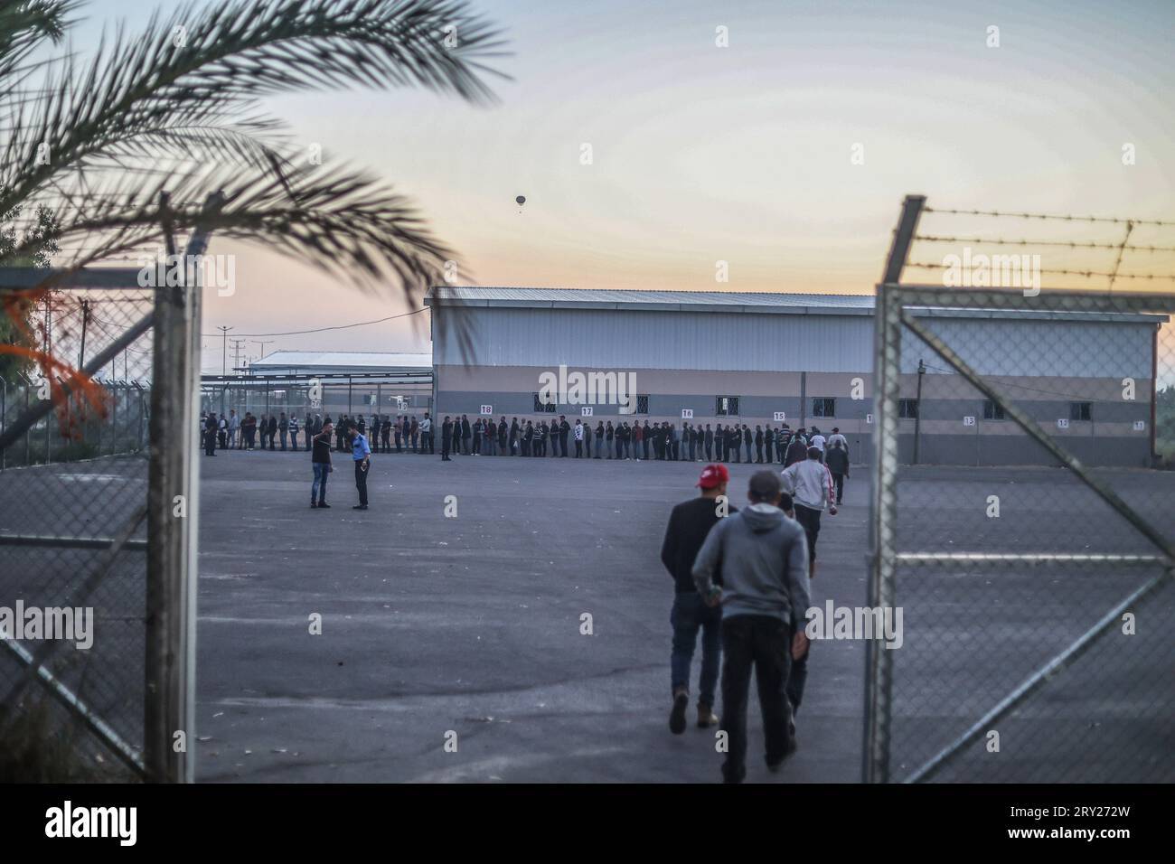 Palestinian workers gather at the Erez crossing between Israel and the ...