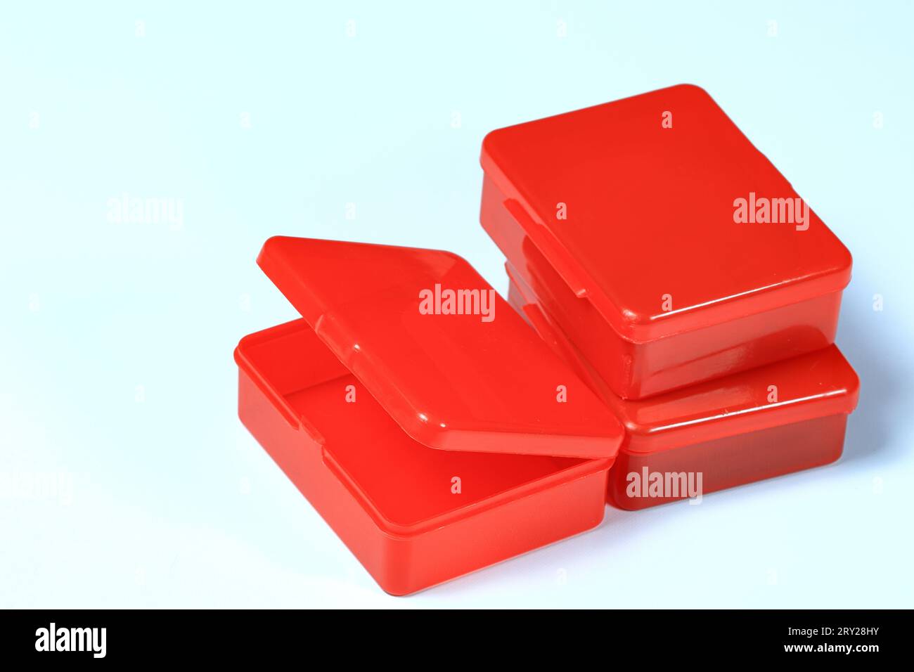 Small transparent red plastic boxes isolated on white background Stock ...