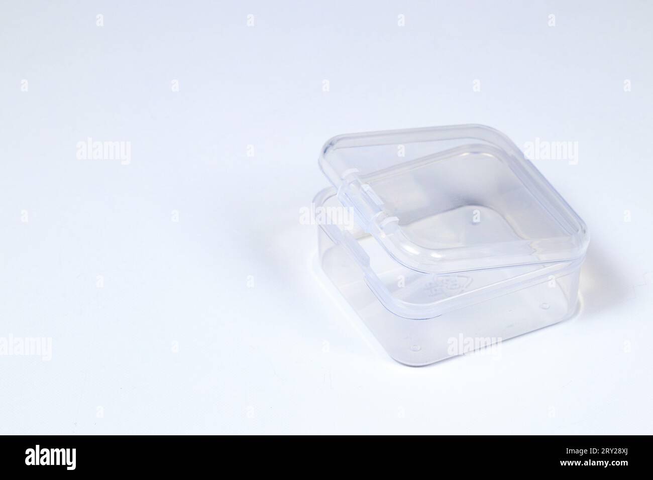 Open empty small transparent plastic box isolated on white background ...