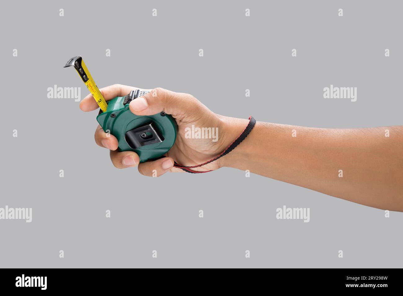 Hand holding tape measure profile Stock Photo - Alamy