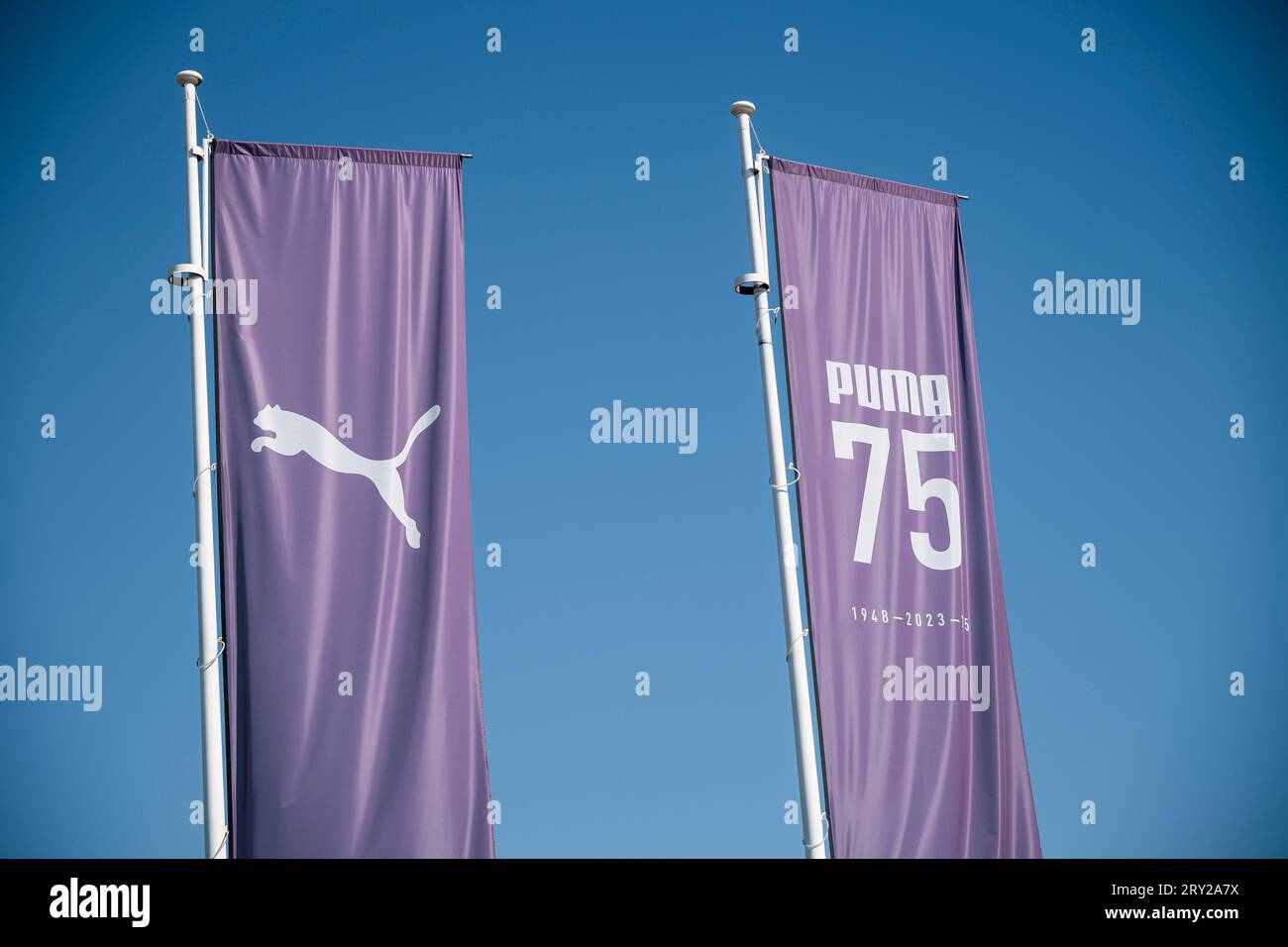 28 September 2023, Bavaria, Herzogenaurach: Flags with the Puma logo on ...
