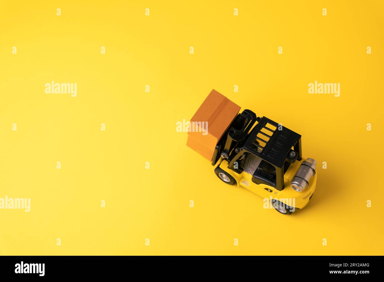 The yellow forklift is busy transporting goods. Freight transportation ...