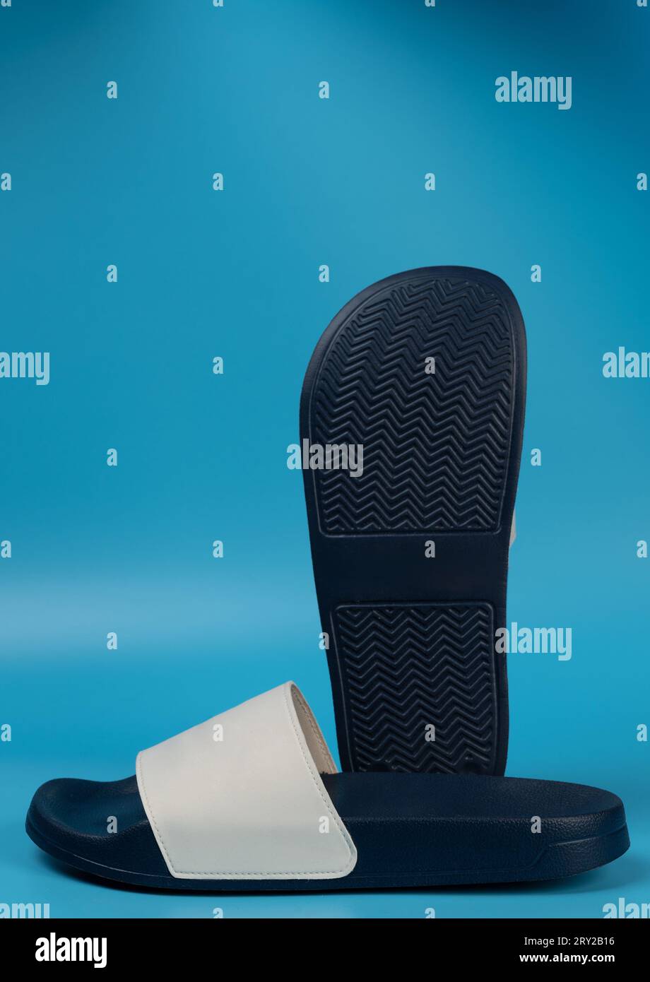 Blue rubber beach flipflops side and sole view on studio background ...