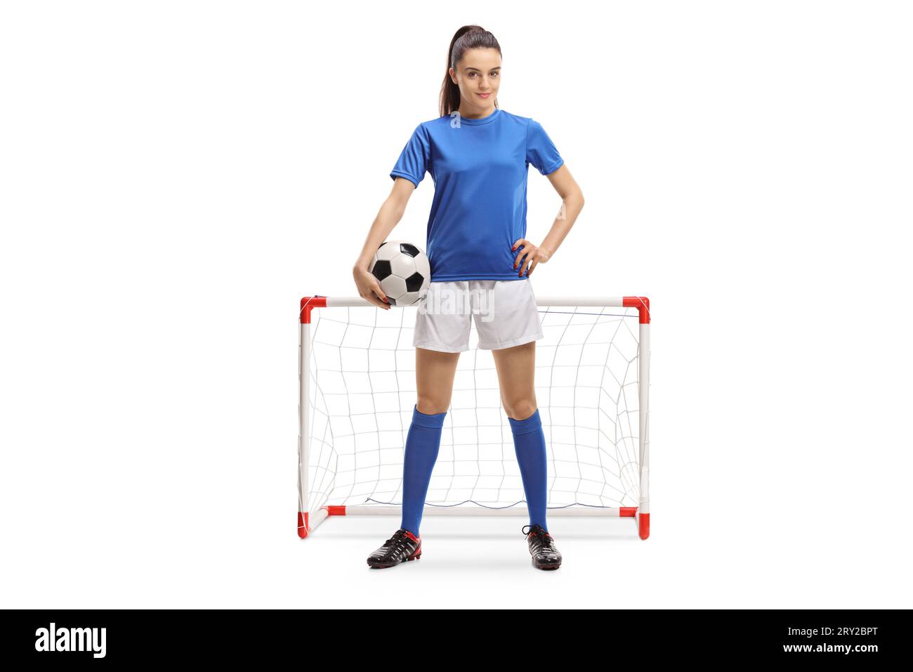 Full length portrait of a female football player with a ball in front ...