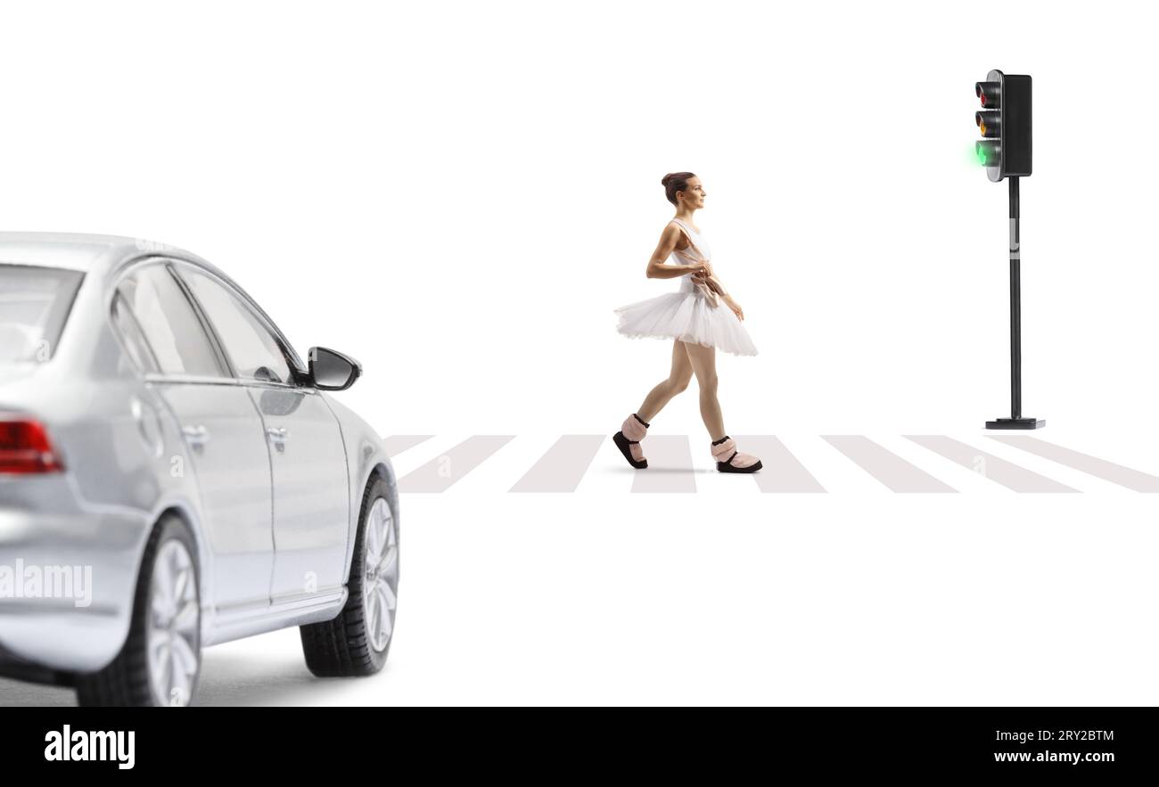 Ballerina carrying toe shoes and crossing a street at pedestrian zerba ...