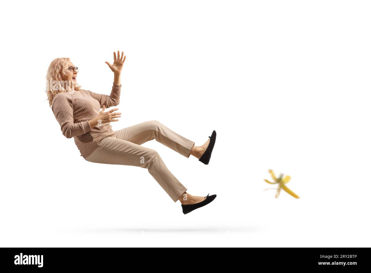Full length profile shot of a woman falling on a banana skin isolated ...