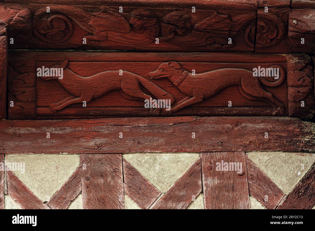 Dog chasing fox. Carved in bas-relief on upper bressumer or load ...