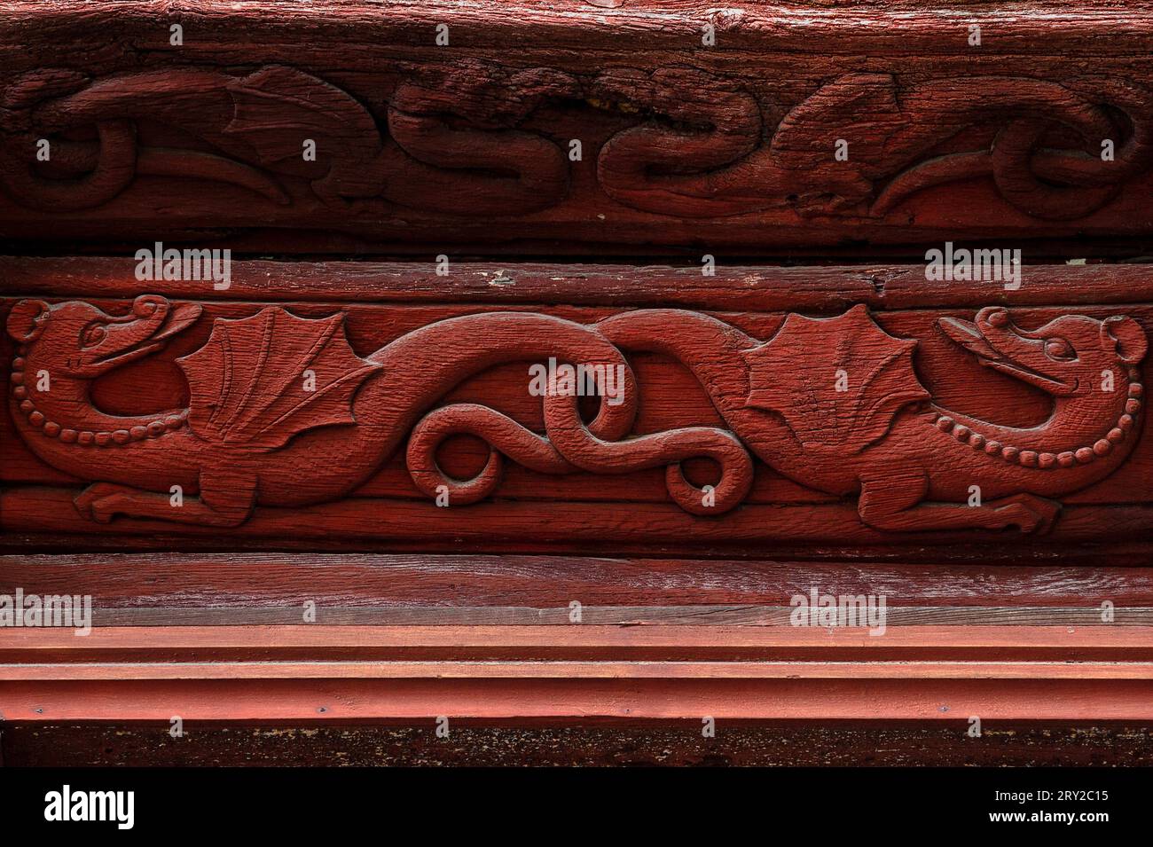 Two long-tongued, winged dragons, tails entwined. Carved in bas-relief ...