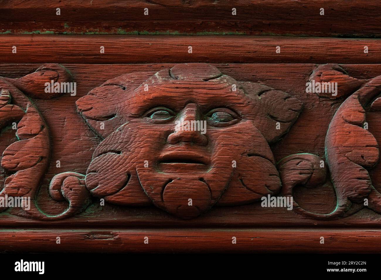 Carved in wood, a staring face surrounded by leaves. On lower bressumer ...