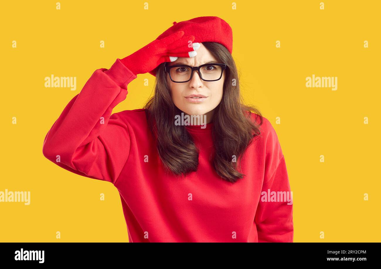 Woman in red beret and glasses looks at something with shocked ...
