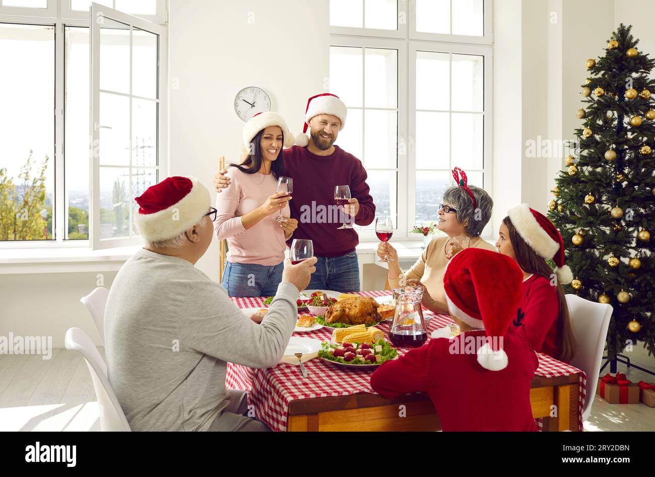 Happy family celebrating Christmas, eating festive meal, pronouncing ...