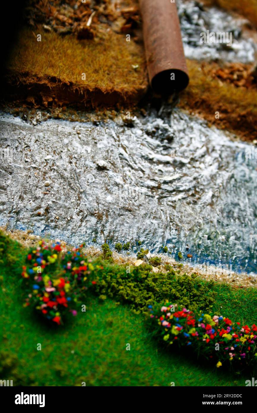 Diorama of a leaking sewage pipe with it also discharging into a river ...