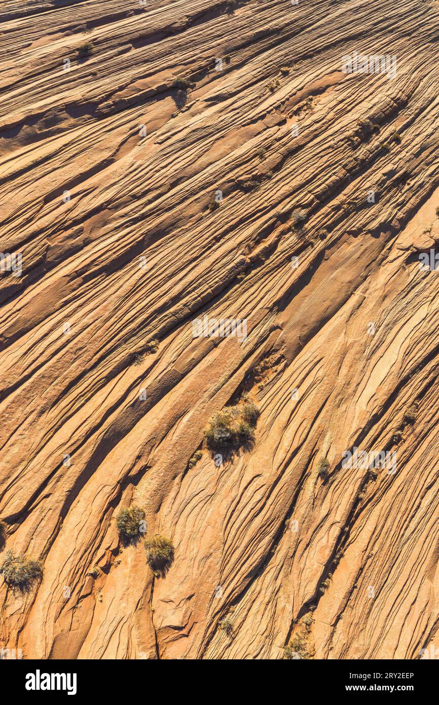 Rough textured surface of sandstone cliff with cracks and uneven lines ...