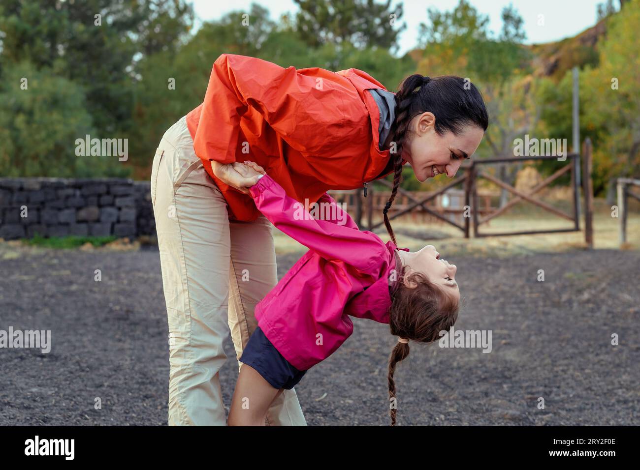 In An Outdoor Setting Possibly A Park Or Agriturismo A Mother Holds