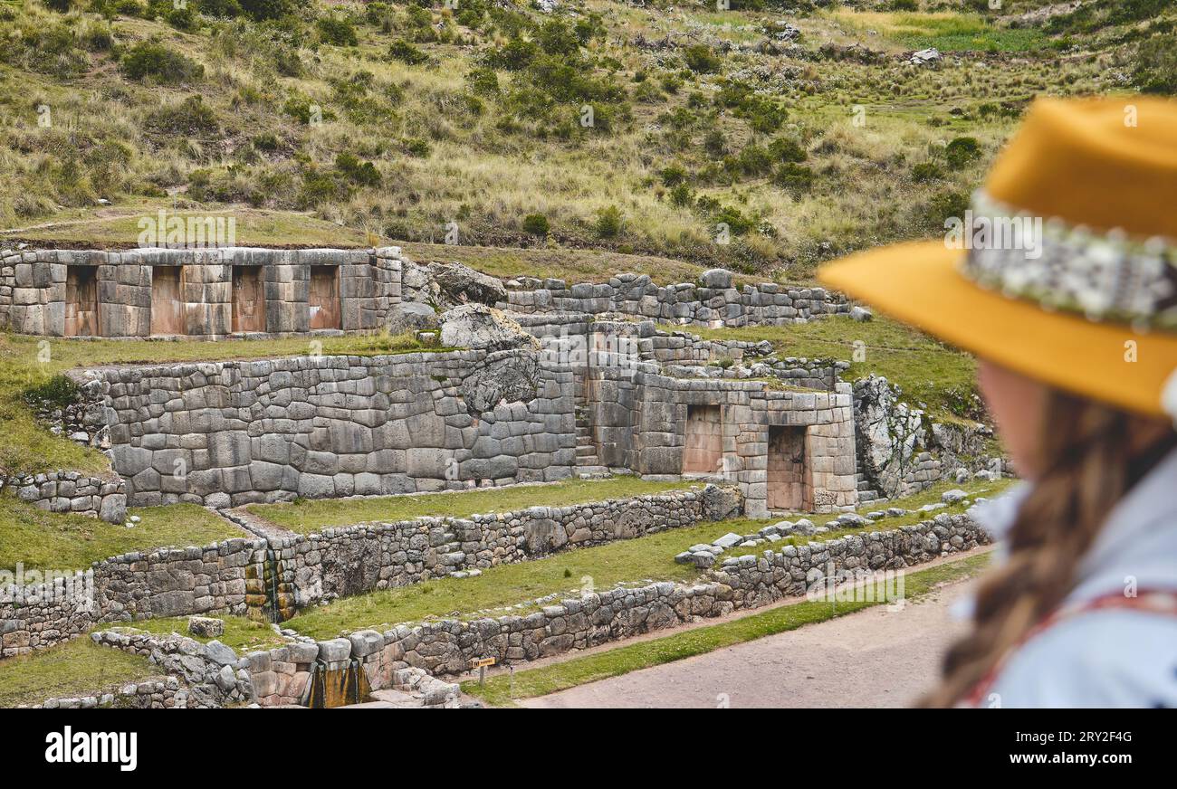 Beautiful tourist girl exploring Tambomachay Inca ruins near Cusco in ...