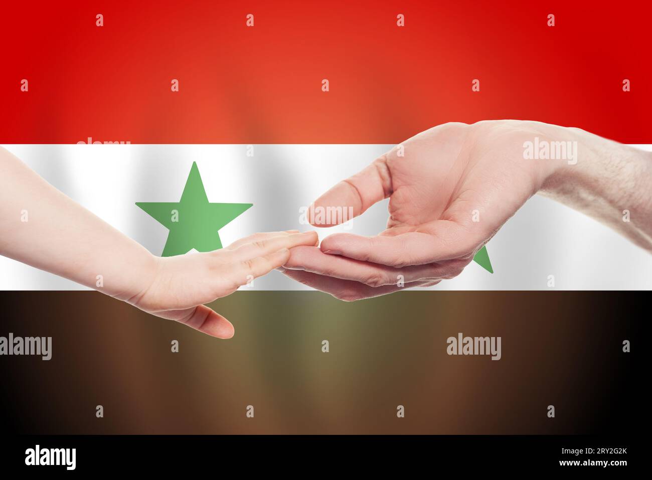 Syrian baby and parent hands on the background of flag of Syria Help ...