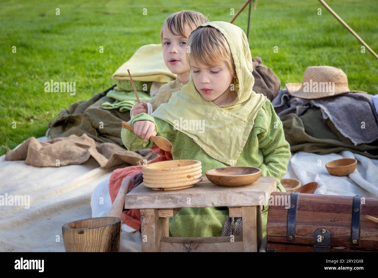 2 young Viking boys taste the food whilst celebrating 1100 years of the ...