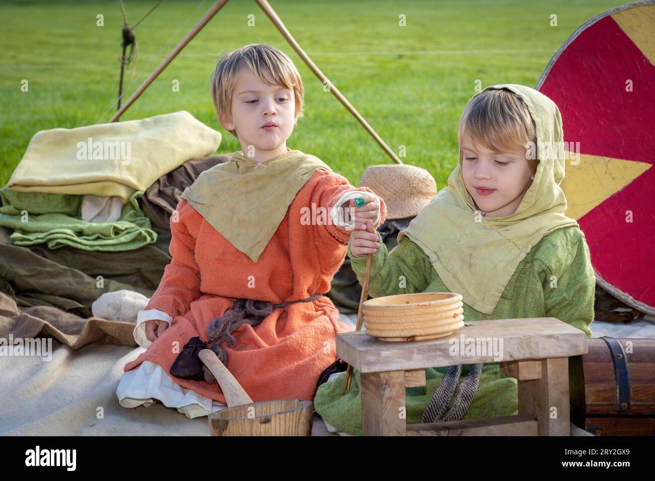 2 young Viking boys taste the food whilst celebrating 1100 years of the ...