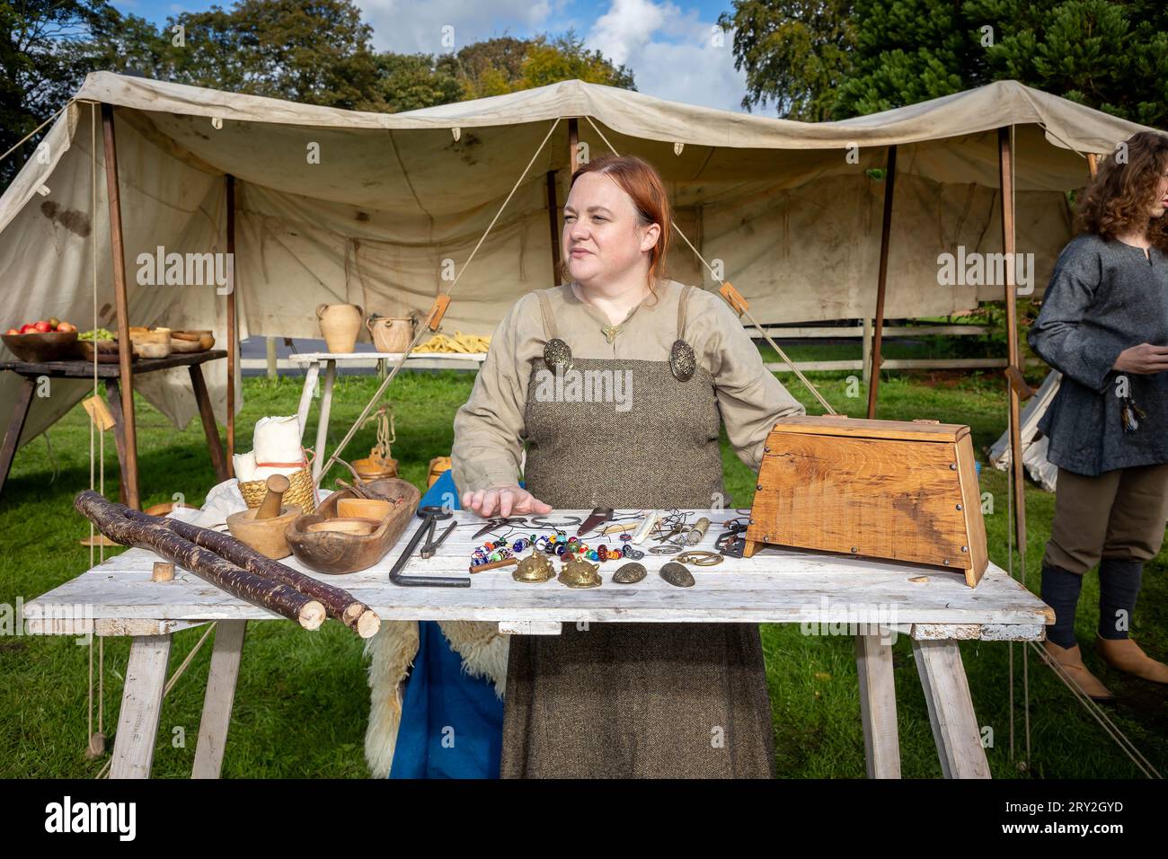 Viking woman at a table of products whilst celebrating 1100 years of ...