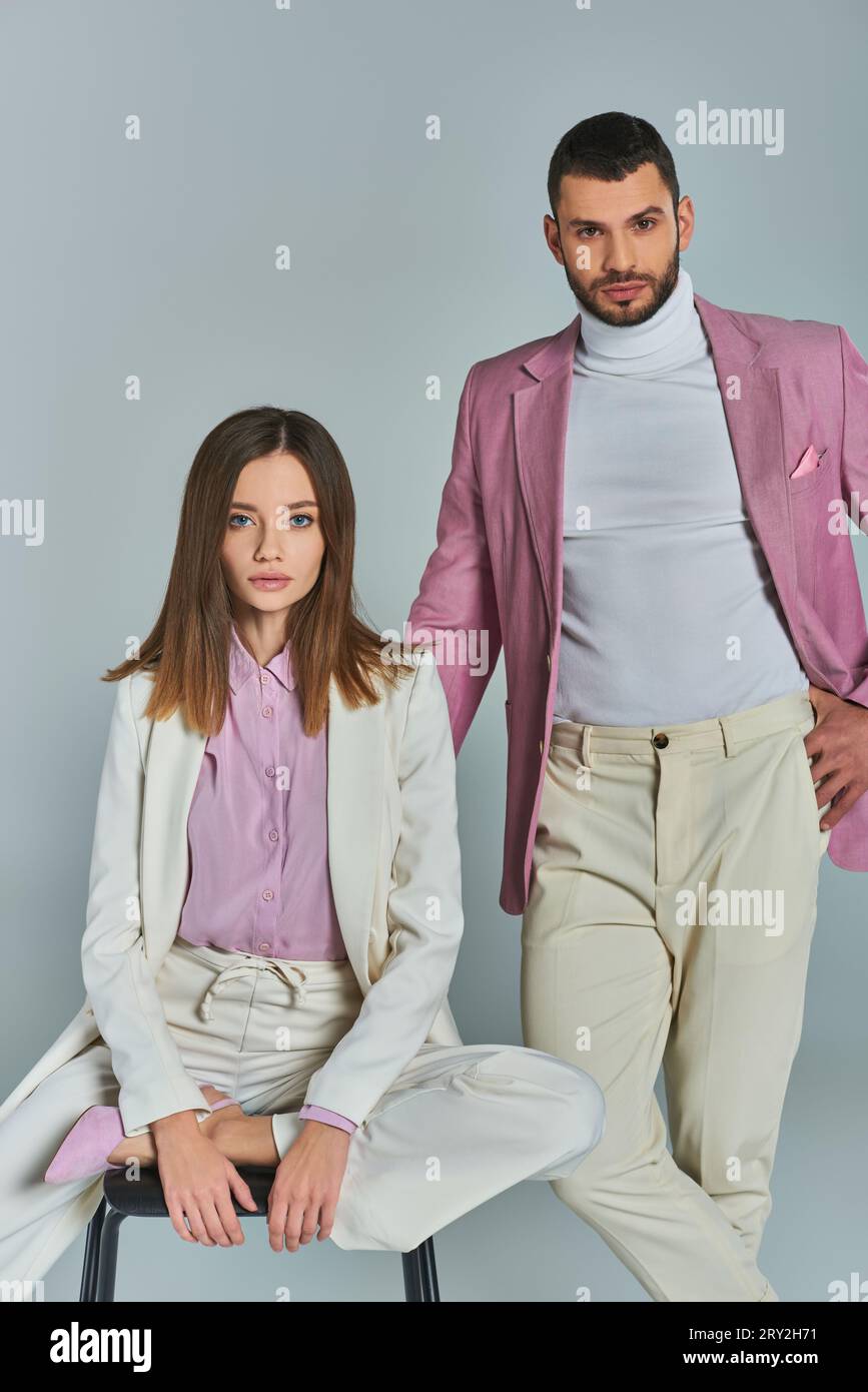 modern and stylish business couple, man with hand on pocket near woman ...