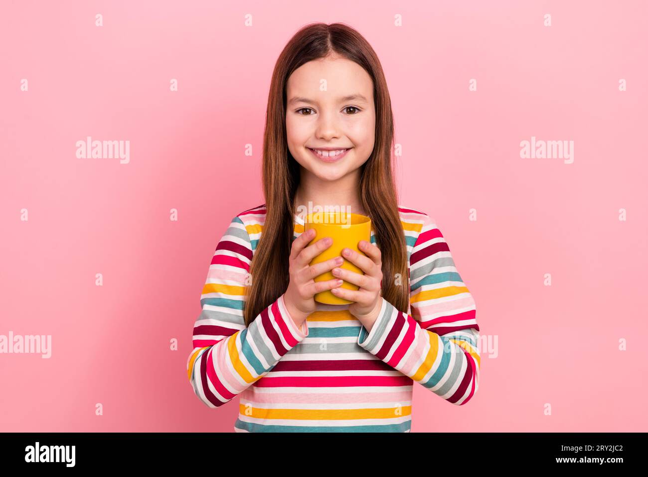 Portrait of smiling healthy life little kid holding orange cup sweet ...